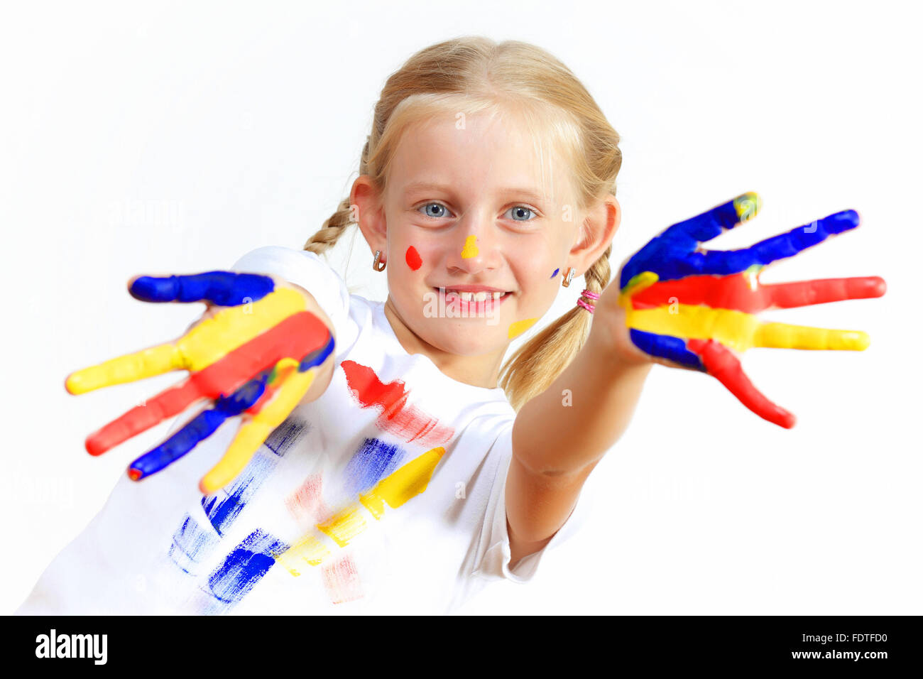 little child with hands painted in colorful paints ready for hand ...