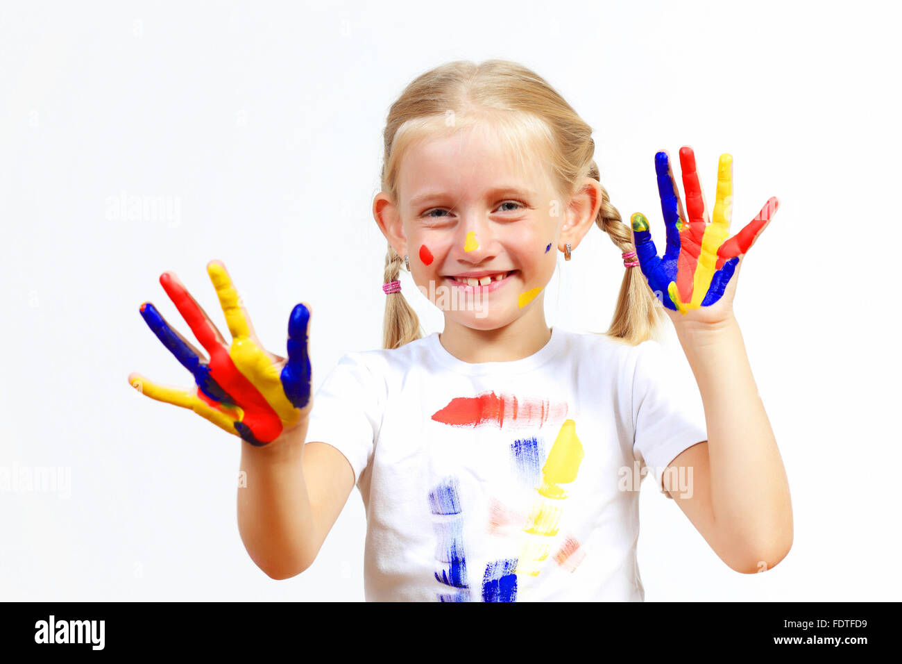 little child with hands painted in colorful paints ready for hand ...