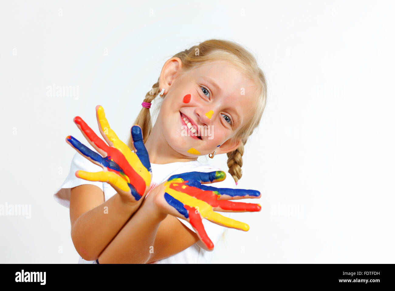 little child with hands painted in colorful paints ready for hand ...