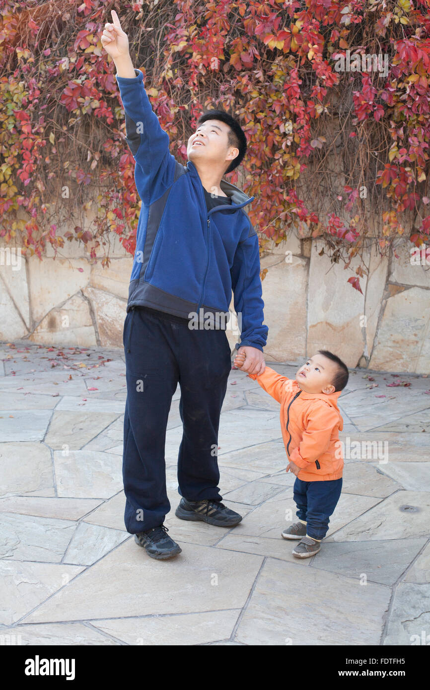 Chinese father and son pointing afar, shot in Beijing, China Stock ...