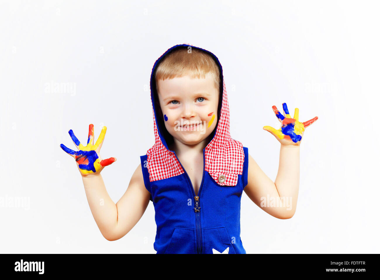 little child with hands painted in colorful paints ready for hand ...