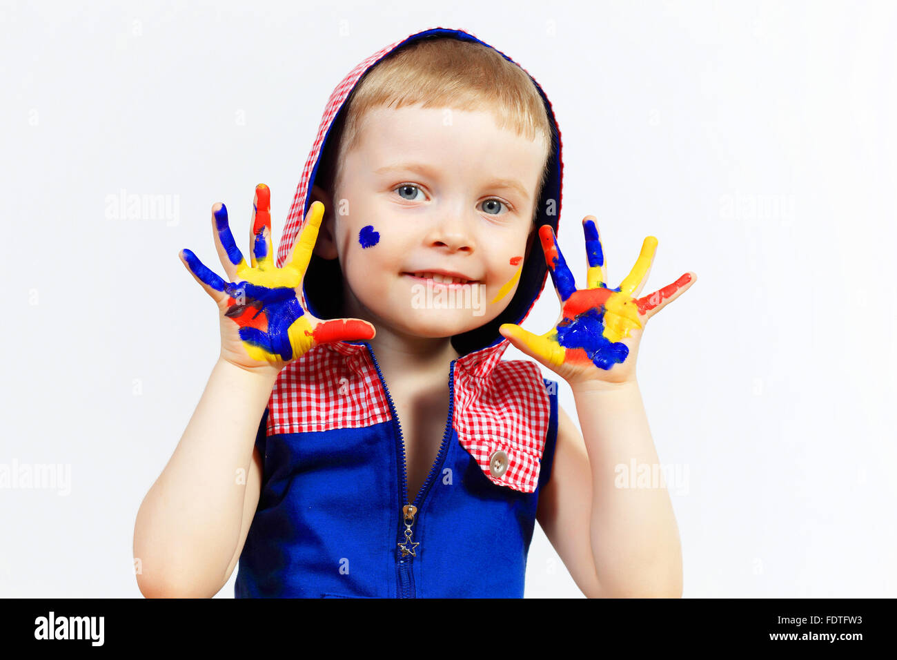 little child with hands painted in colorful paints ready for hand ...