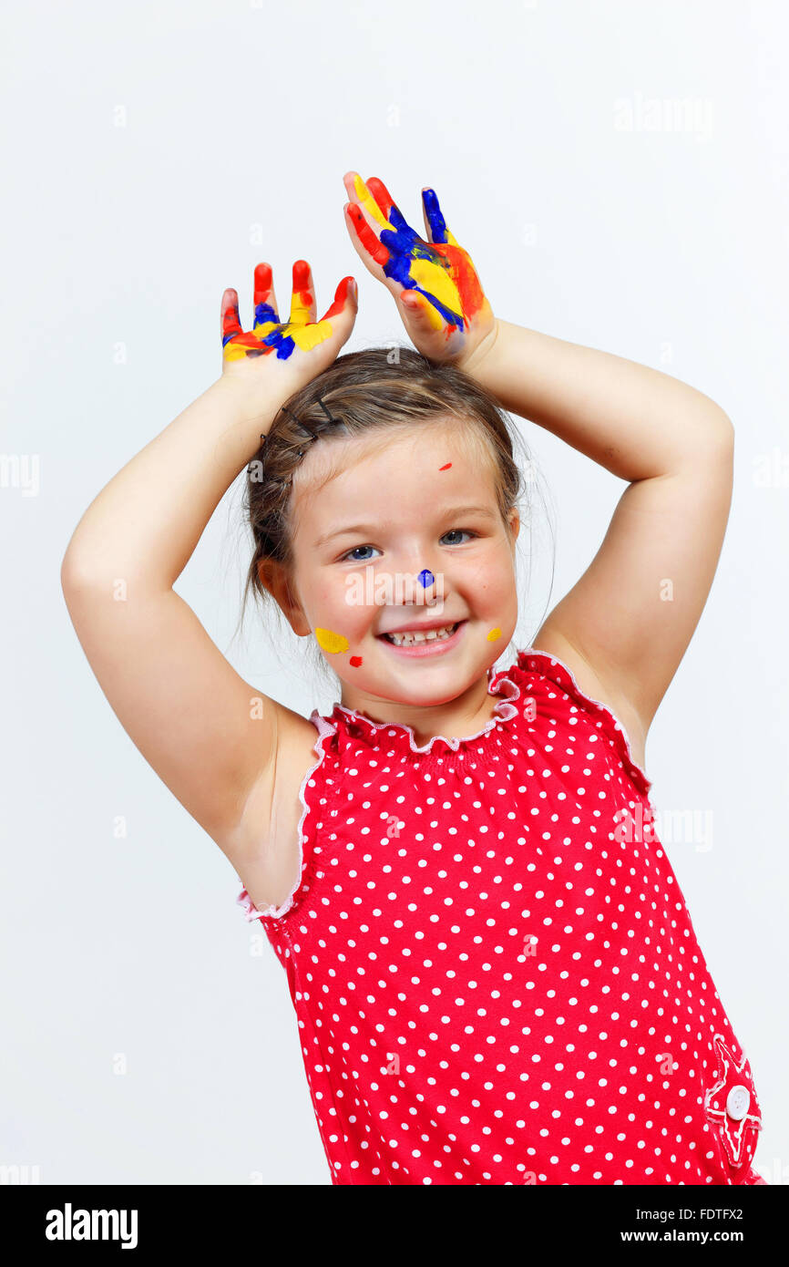 little child with hands painted in colorful paints ready for hand ...