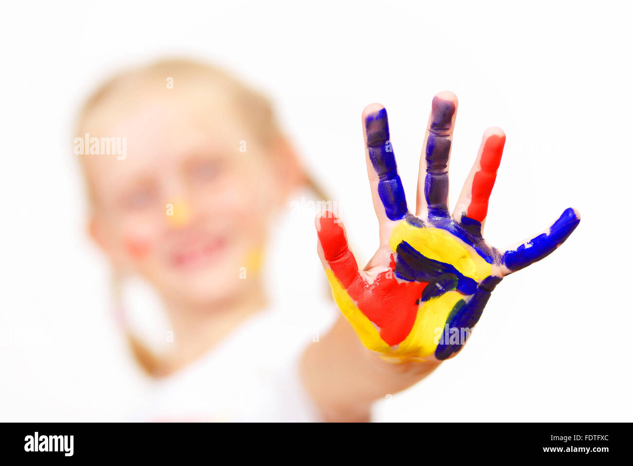 little child with hands painted in colorful paints ready for hand ...