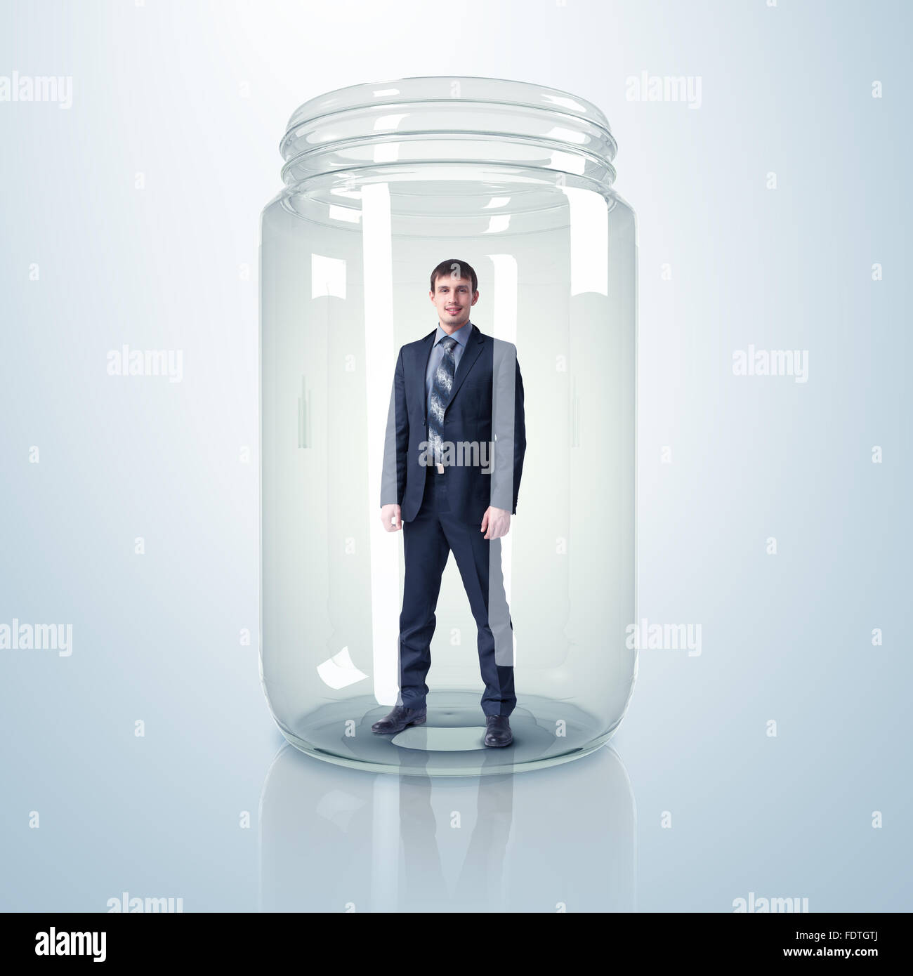 Businessman trapped inside a transparent glass jar Stock Photo - Alamy