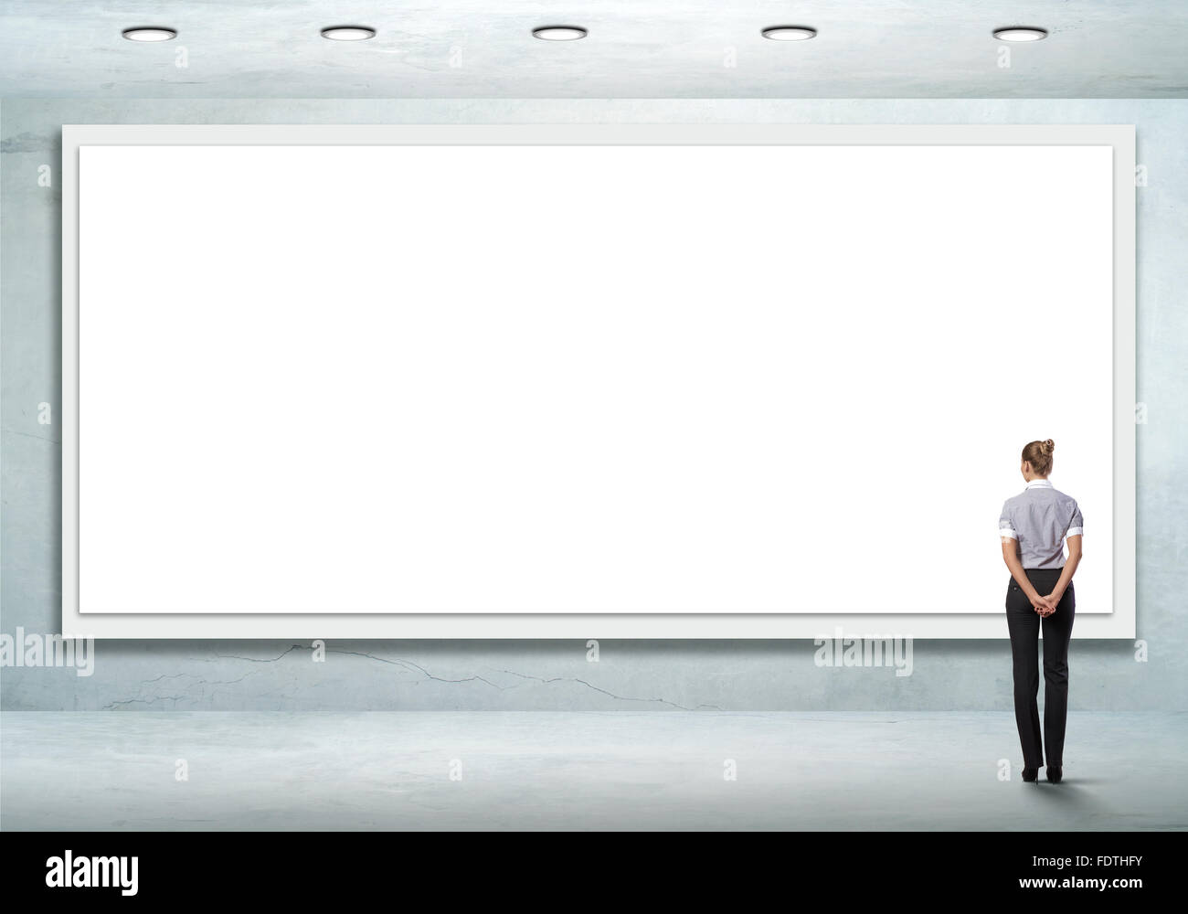 Business person standing near a white blank billboard Stock Photo - Alamy
