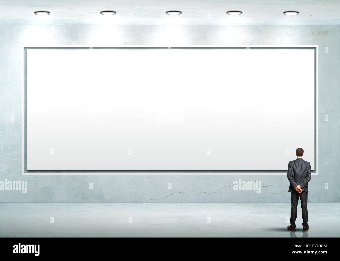 Business person standing near a white blank billboard Stock Photo - Alamy