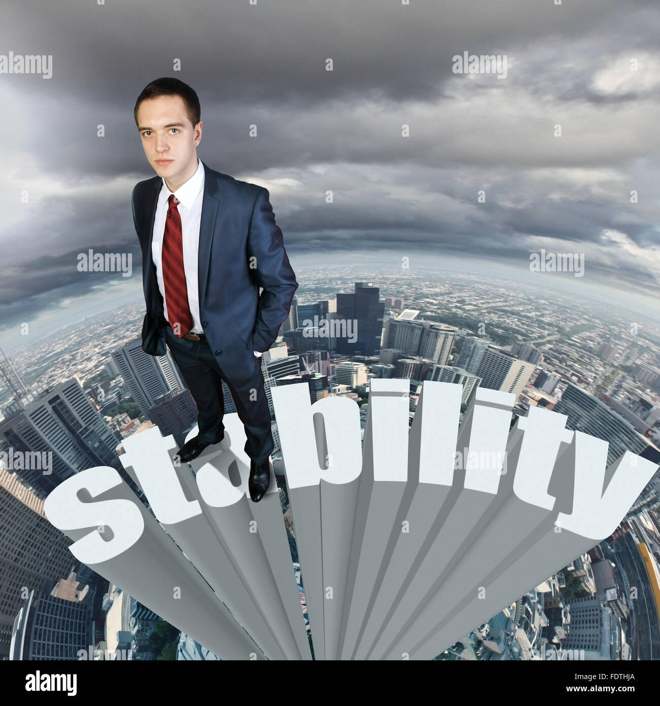 Businessman in suit standing on the word stability Stock Photo - Alamy