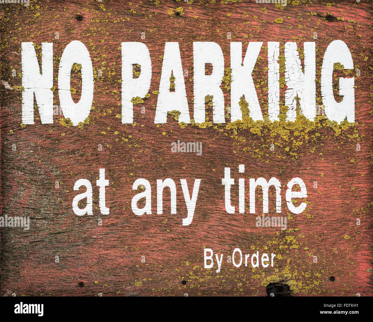 A grungy, weathered wooden "No Parking" sign Stock Photo - Alamy
