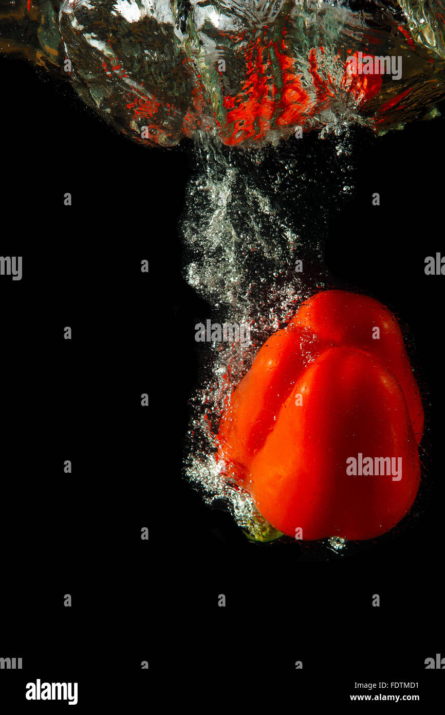 Colored red paprika in water splashes on black background Stock Photo ...