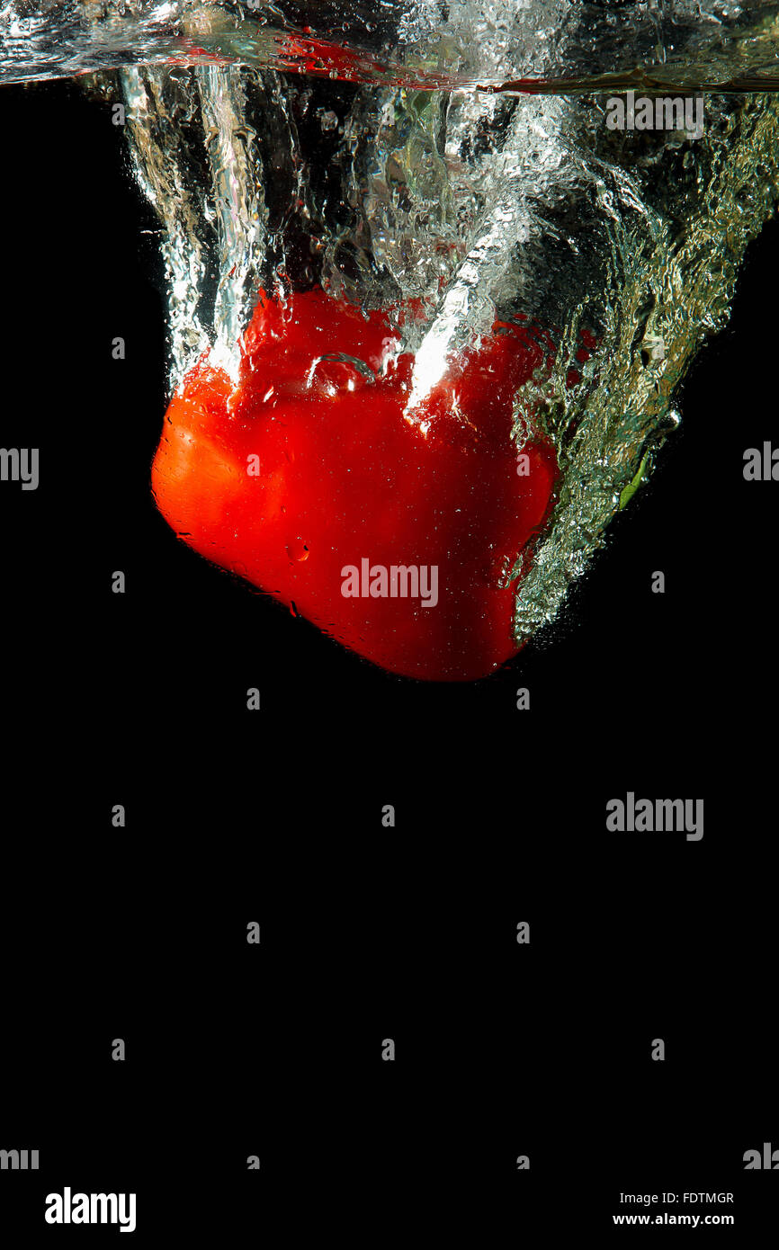 Colored red paprika in water splashes on black background Stock Photo ...