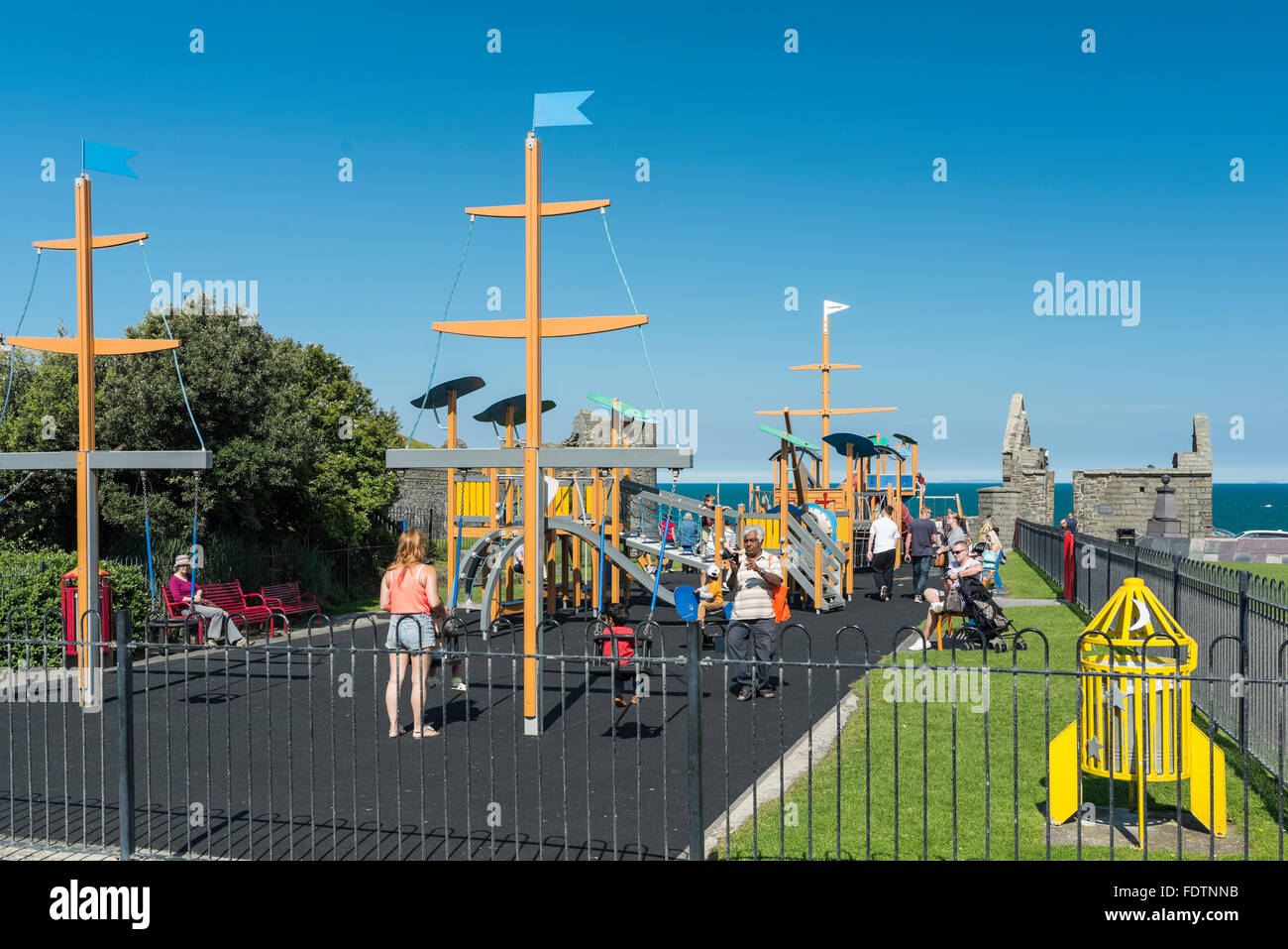 Children playing in a playground with a nautical theme with the sea in ...