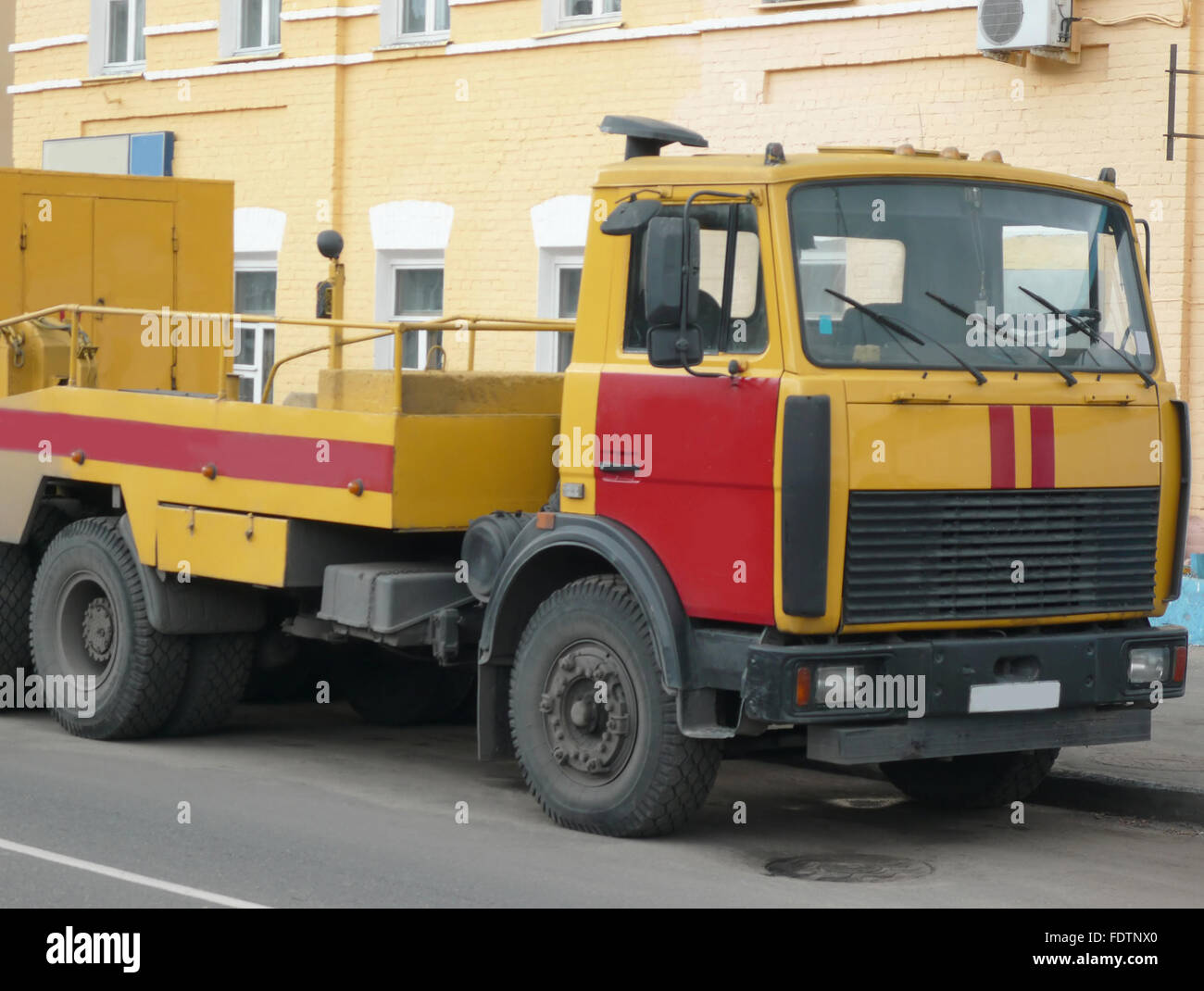 red-yellow emergency truck on asphalt road Stock Photo - Alamy