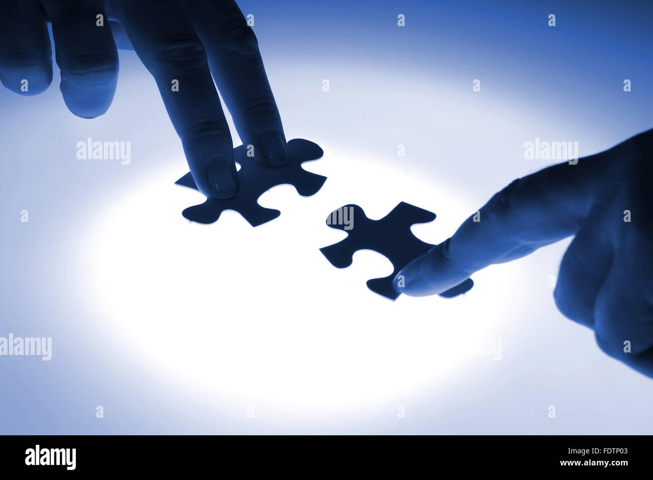 puzzle piece coming down into its place Stock Photo - Alamy