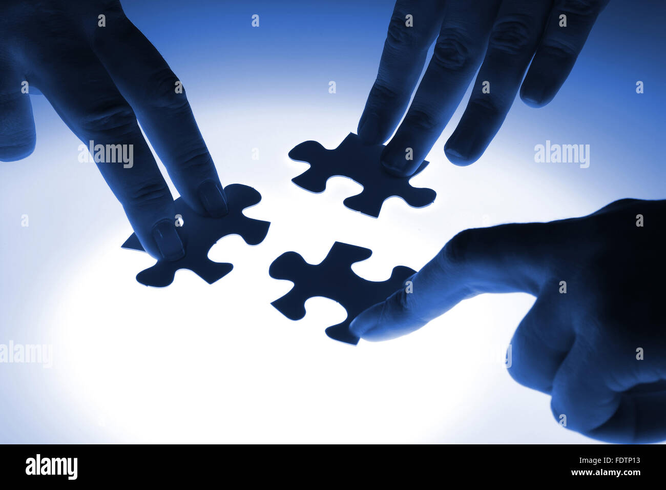 puzzle piece coming down into its place Stock Photo - Alamy