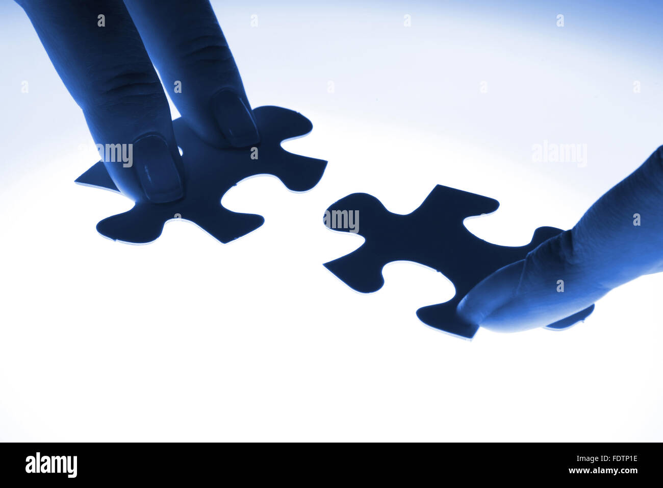 puzzle piece coming down into its place Stock Photo - Alamy