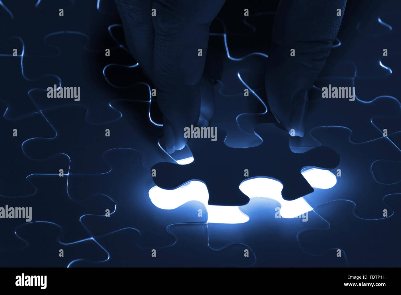 puzzle piece coming down into its place Stock Photo - Alamy