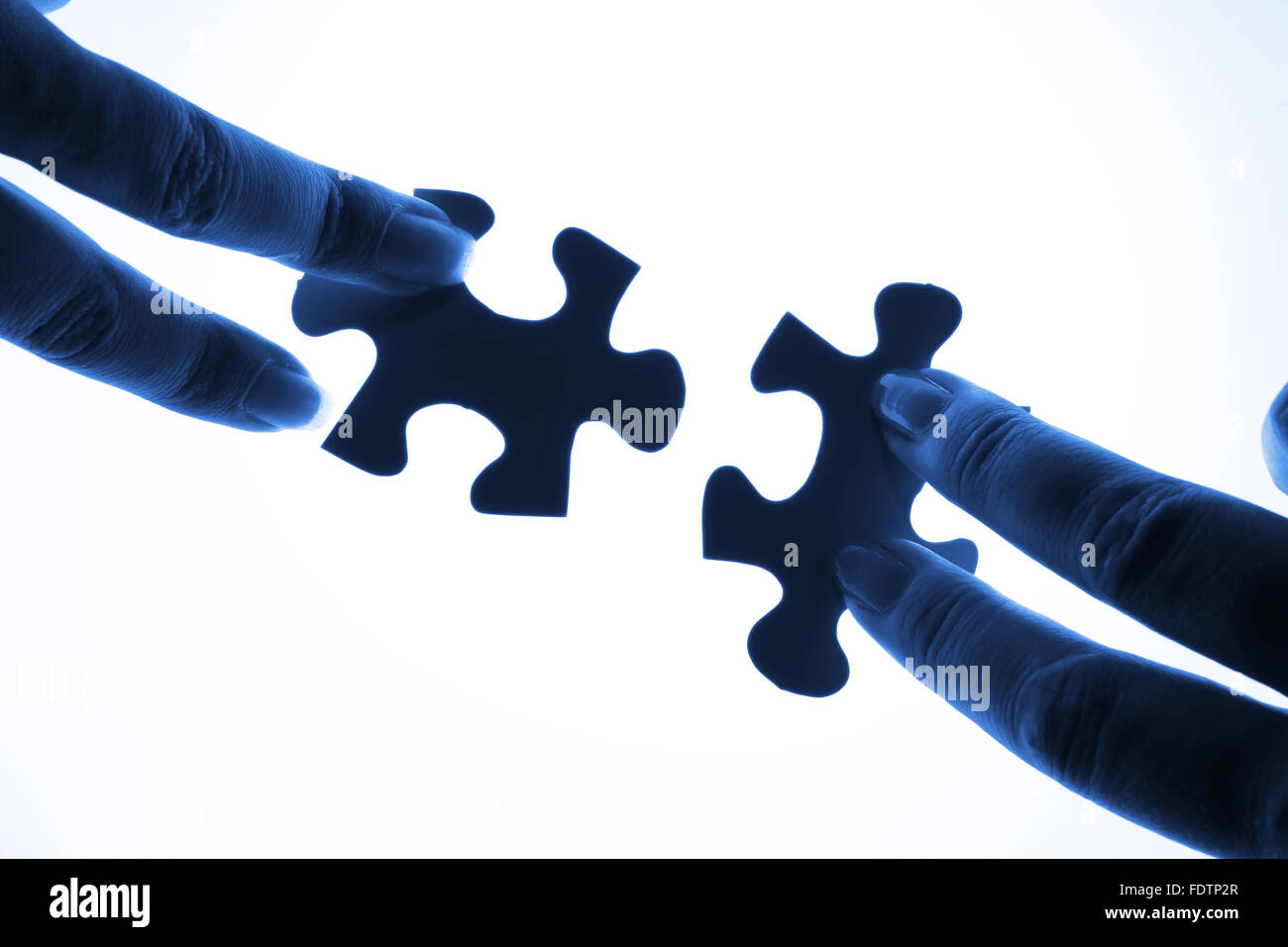puzzle piece coming down into its place Stock Photo - Alamy