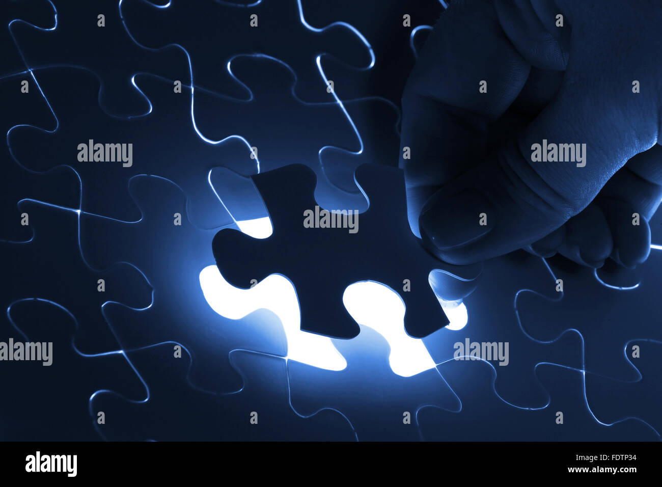 puzzle piece coming down into its place Stock Photo - Alamy