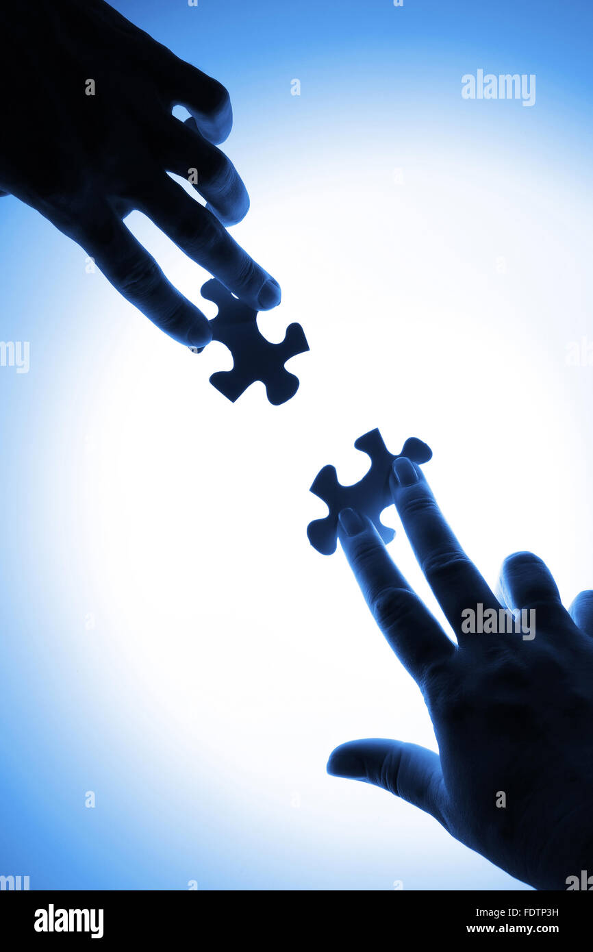 puzzle piece coming down into its place Stock Photo - Alamy