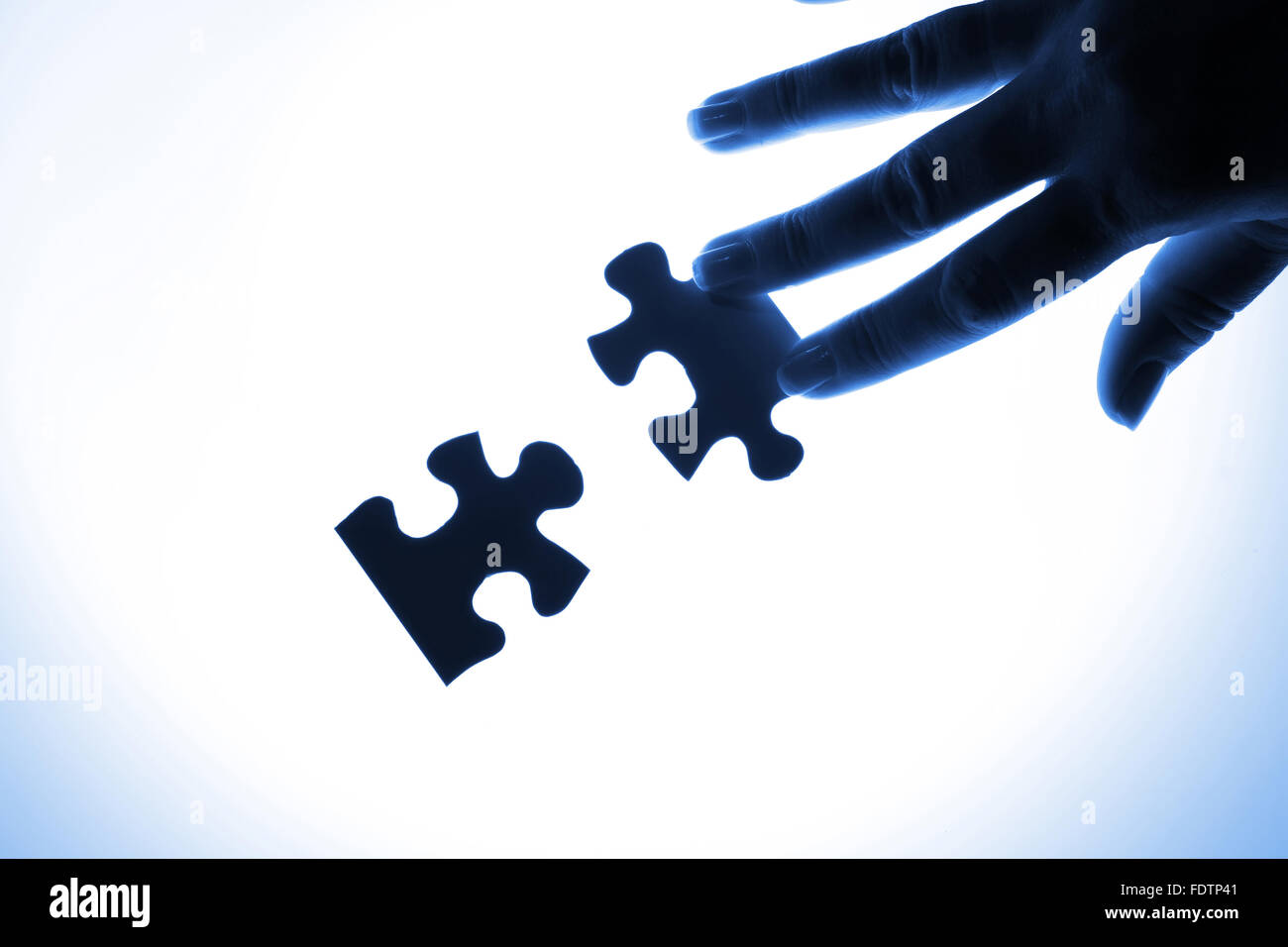 puzzle piece coming down into its place Stock Photo - Alamy