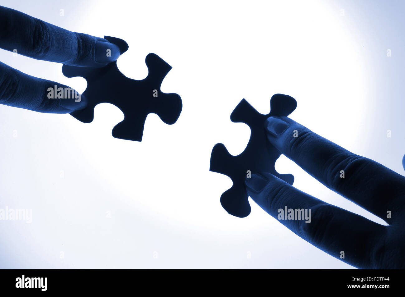 puzzle piece coming down into its place Stock Photo - Alamy