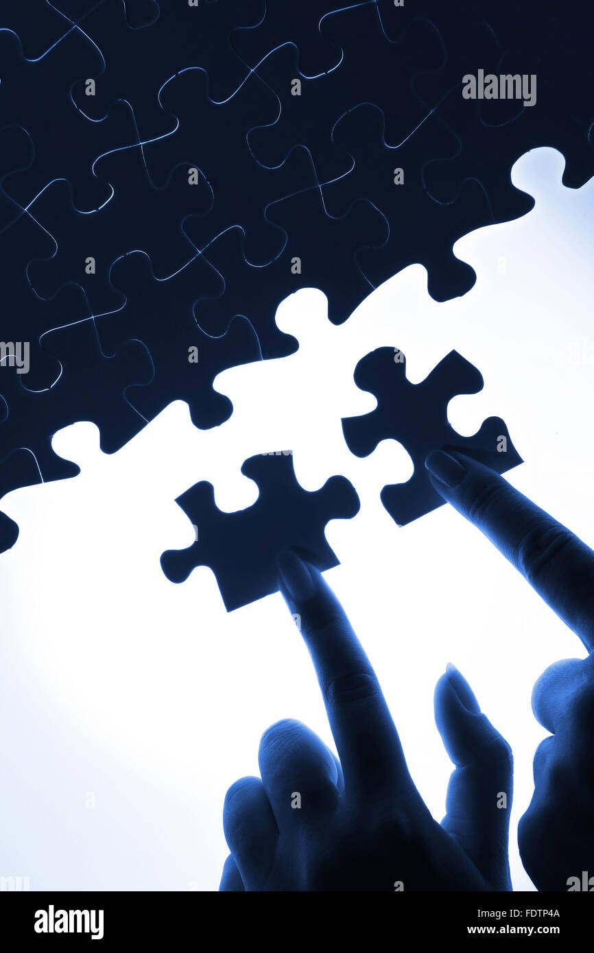 puzzle piece coming down into its place Stock Photo - Alamy