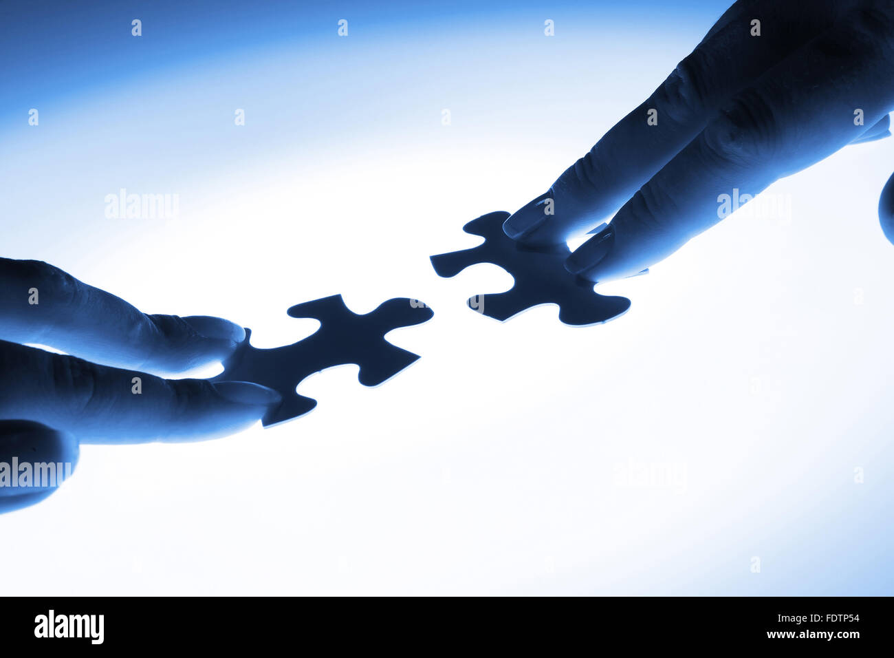 puzzle piece coming down into its place Stock Photo - Alamy