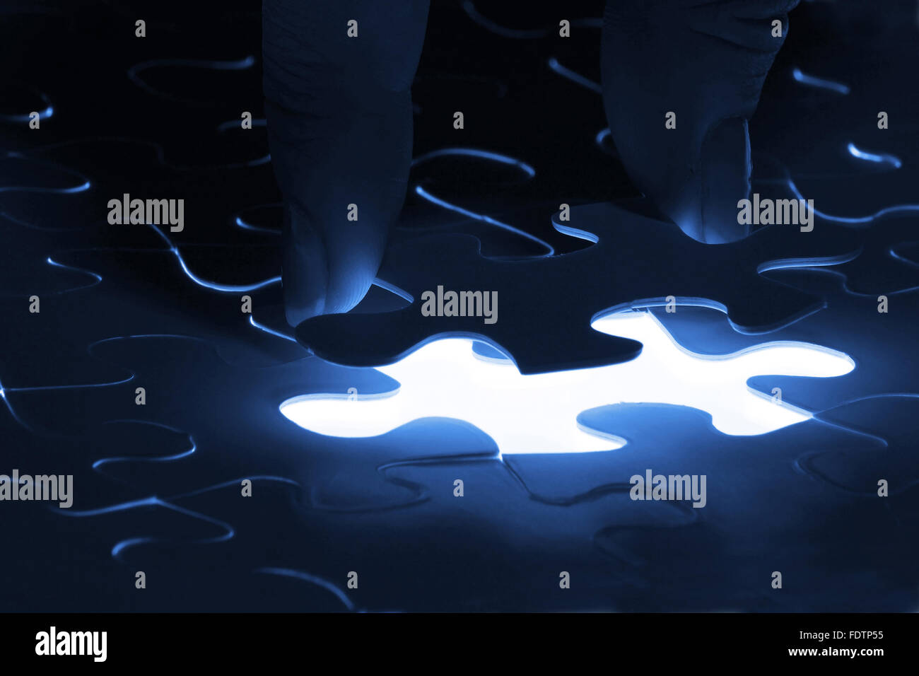 puzzle piece coming down into its place Stock Photo - Alamy