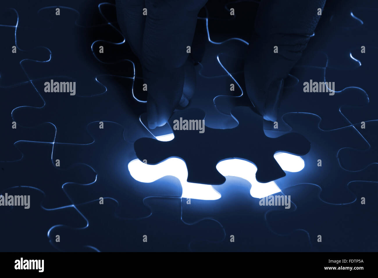 puzzle piece coming down into its place Stock Photo - Alamy