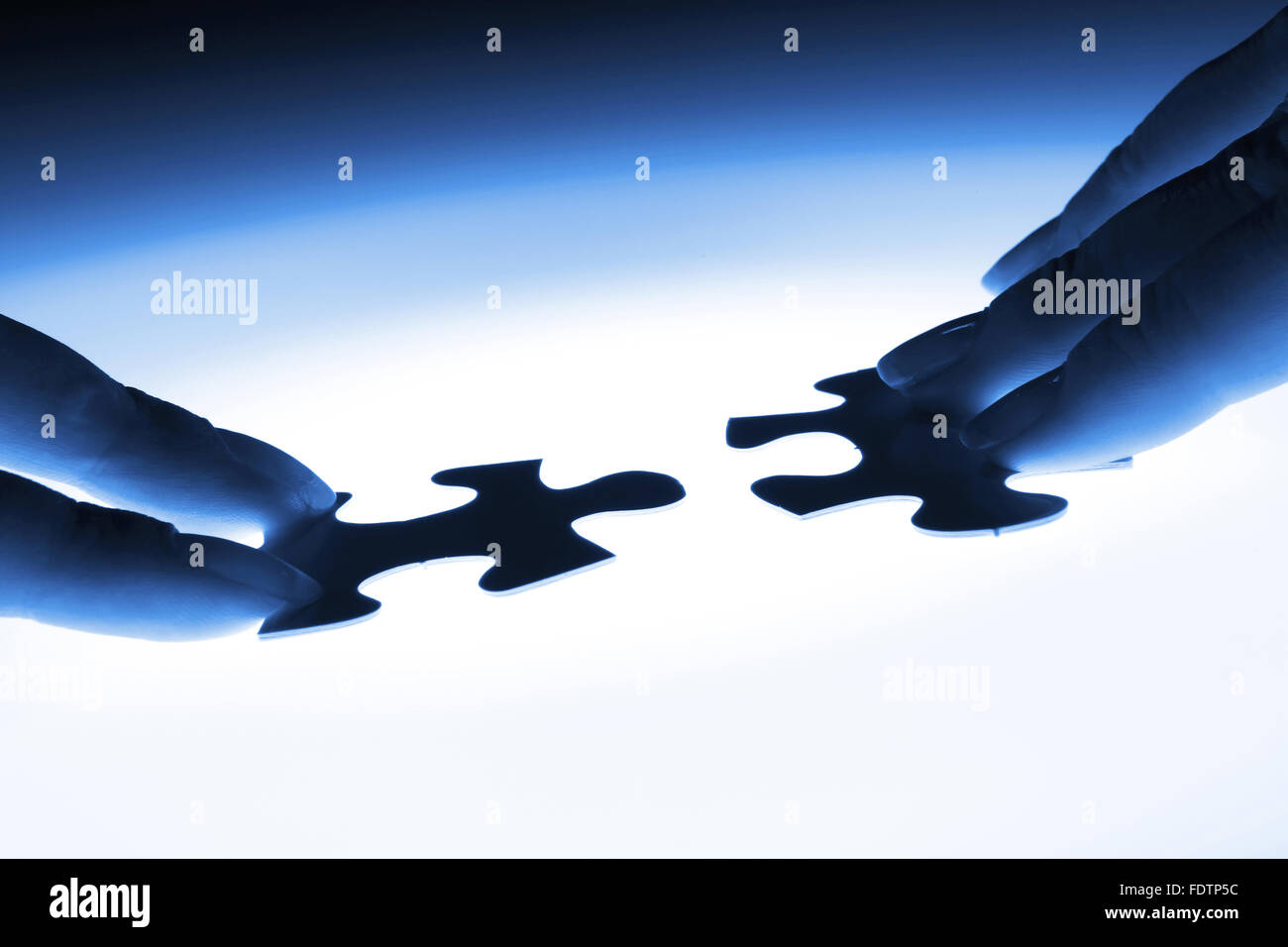 puzzle piece coming down into its place Stock Photo - Alamy