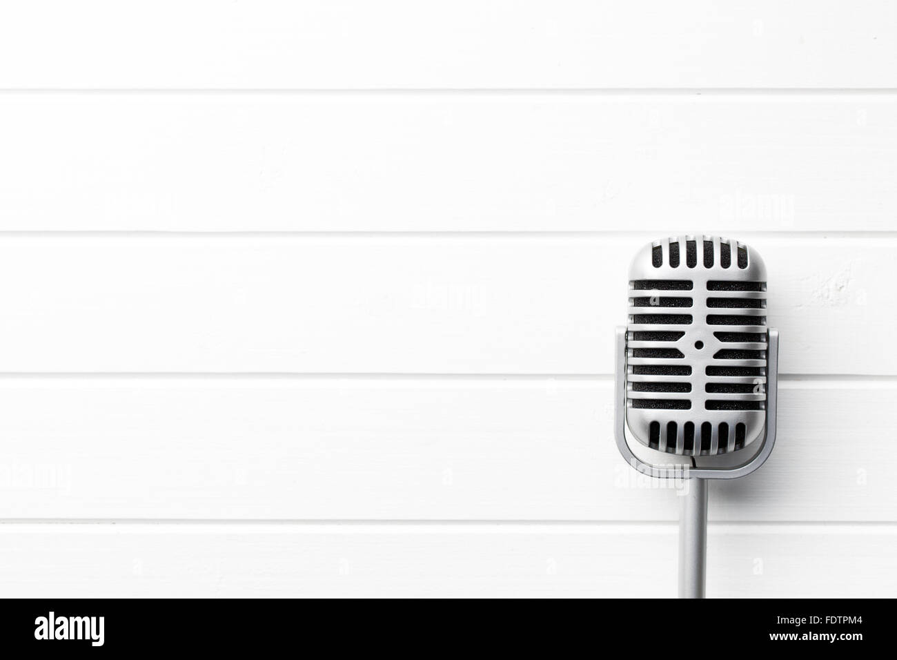 vintage microphone on white wooden background Stock Photo - Alamy