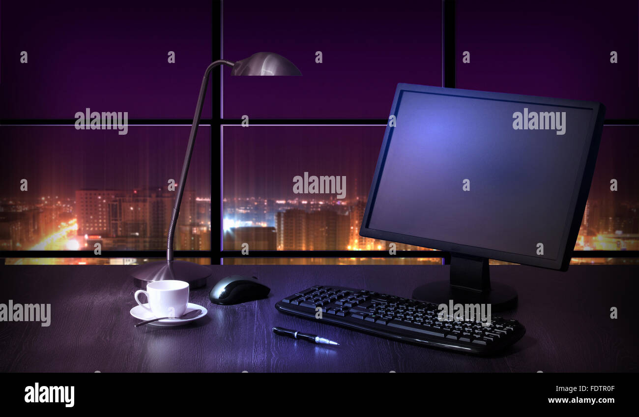 Work place in the office at night with a city view from window Stock ...