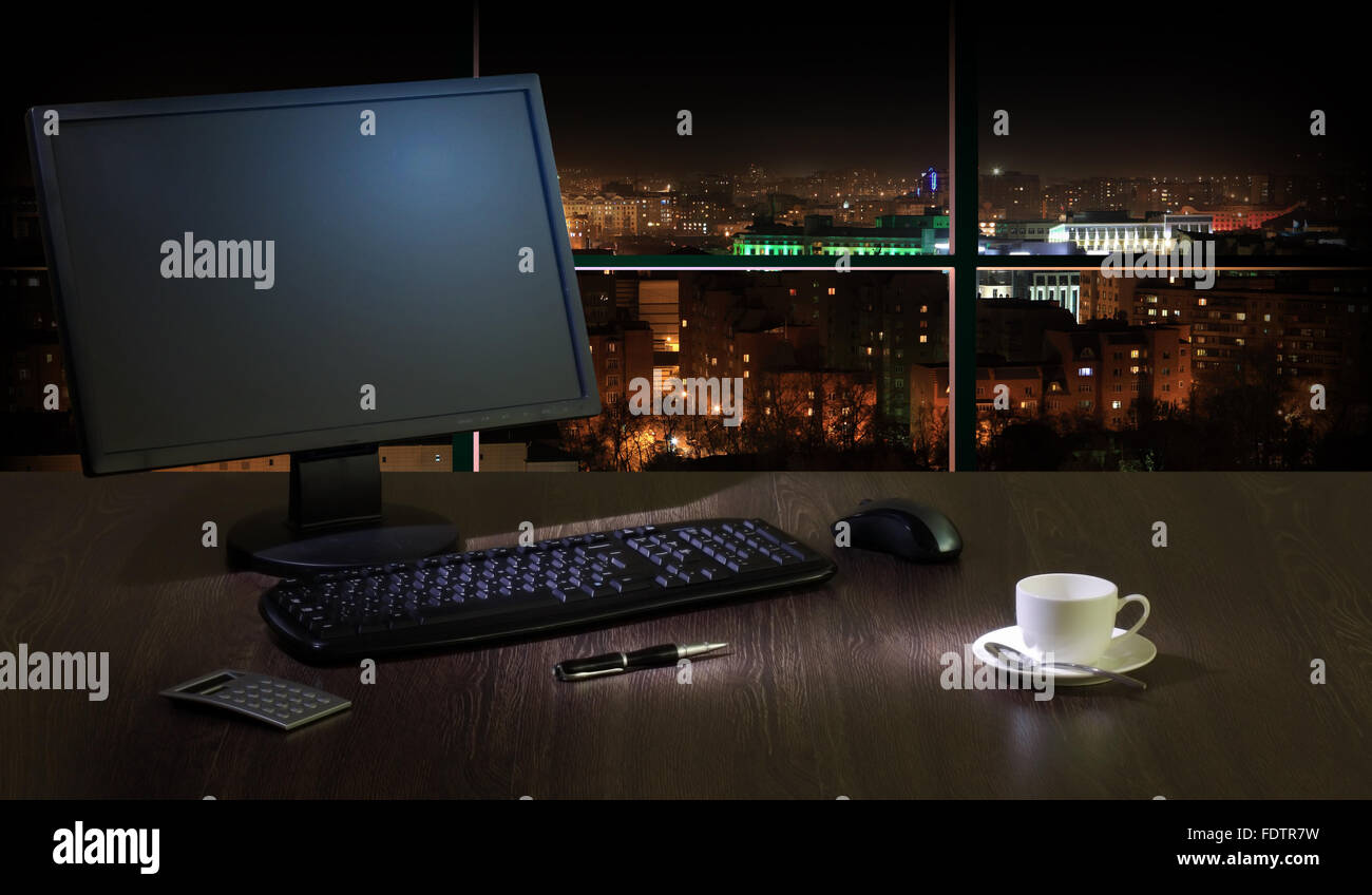 Work place in the office at night with a city view from window Stock ...