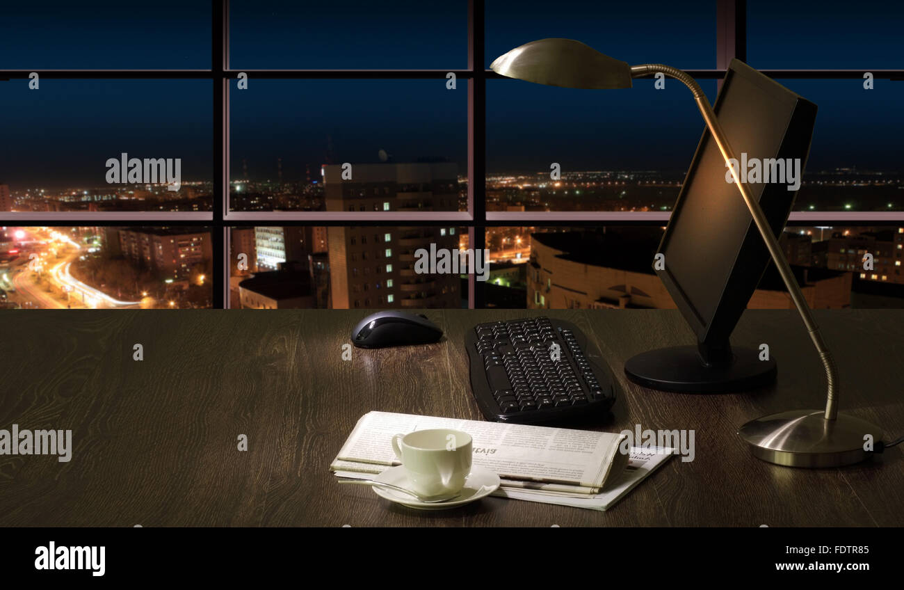 Work place in the office at night with a city view from window Stock ...