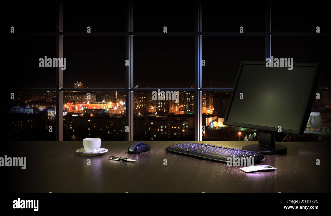 Work place in the office at night with a city view from window Stock ...