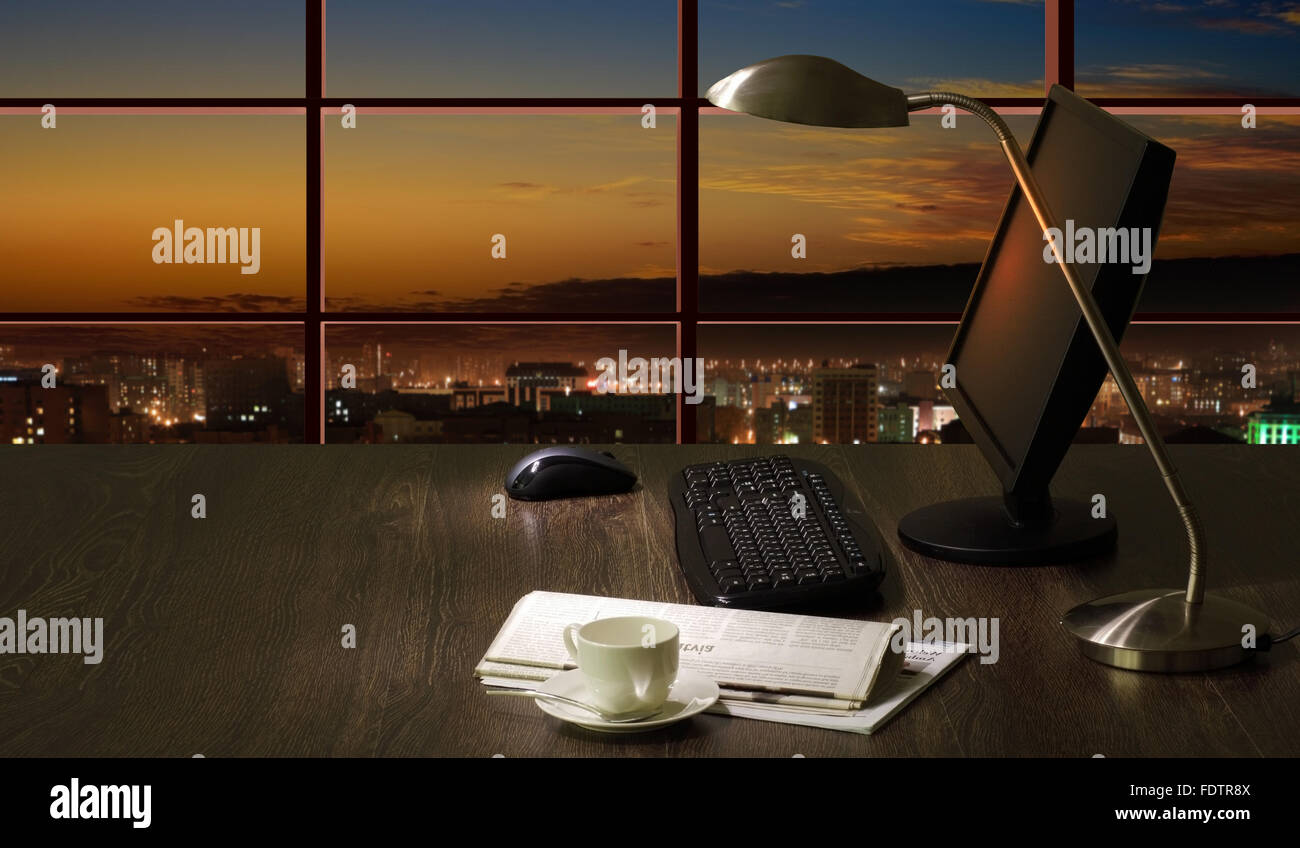 Work place in the office at night with a city view from window Stock ...