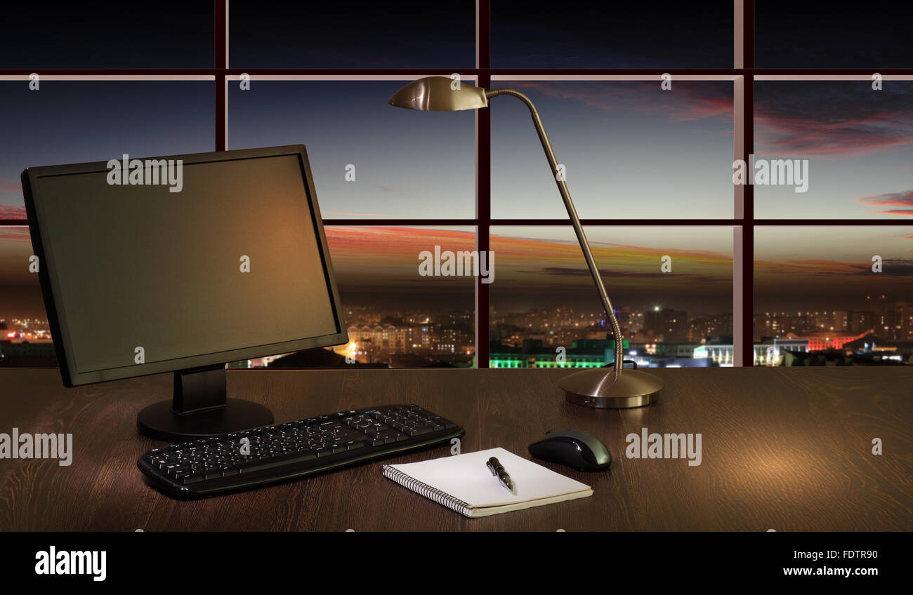 Work place in the office at night with a city view from window Stock ...