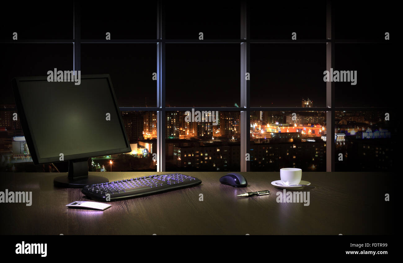 Work place in the office at night with a city view from window Stock ...