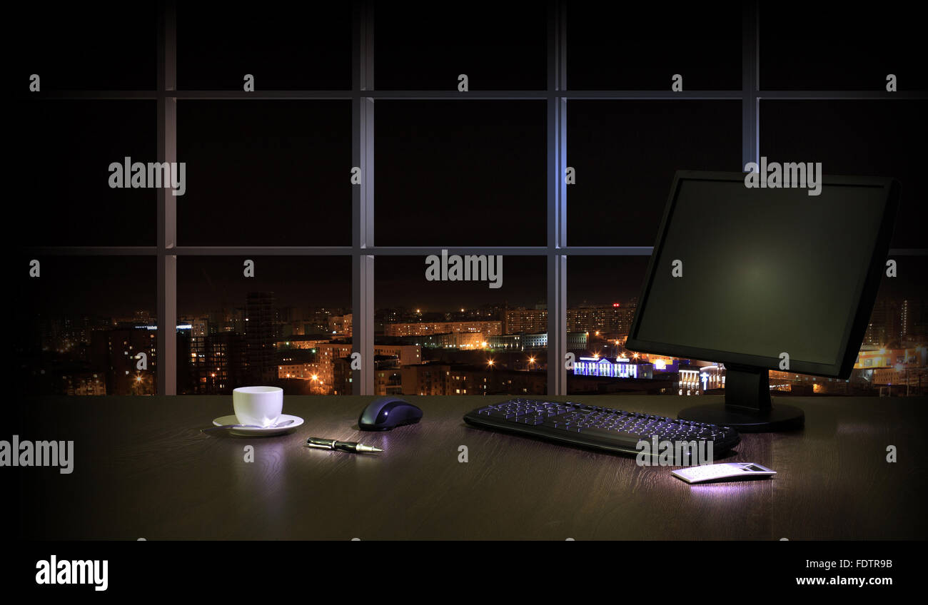 Work place in the office at night with a city view from window Stock ...