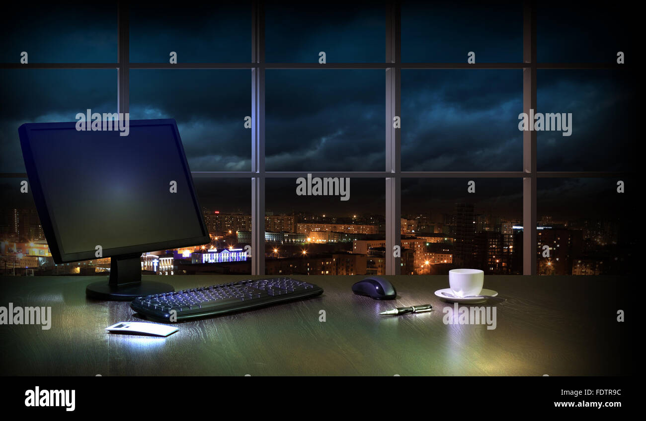 Work place in the office at night with a city view from window Stock ...