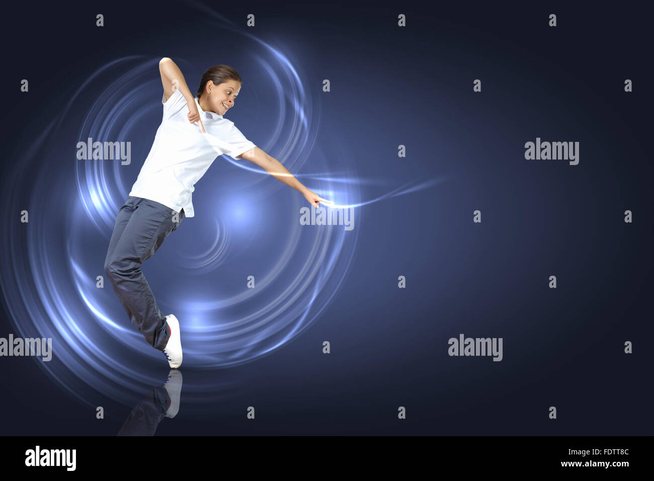 Modern style dancer posing against dark background with light effects ...