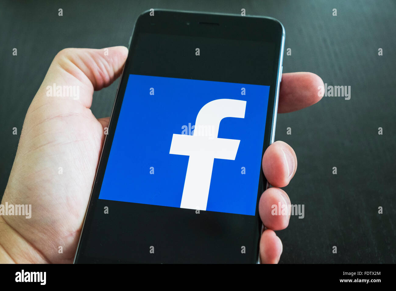 Facebook social media app logo on screen of iPhone 6 Plus smart phone ...