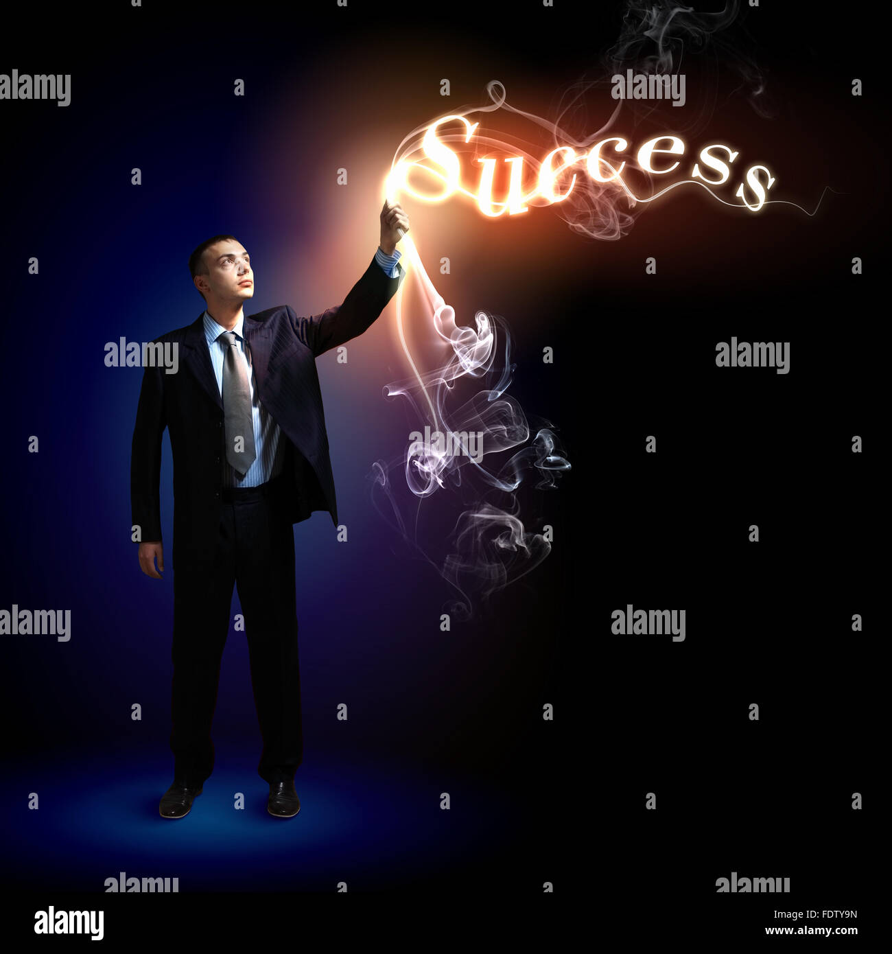 Young successful businessman holding a shining light in his hand as a ...