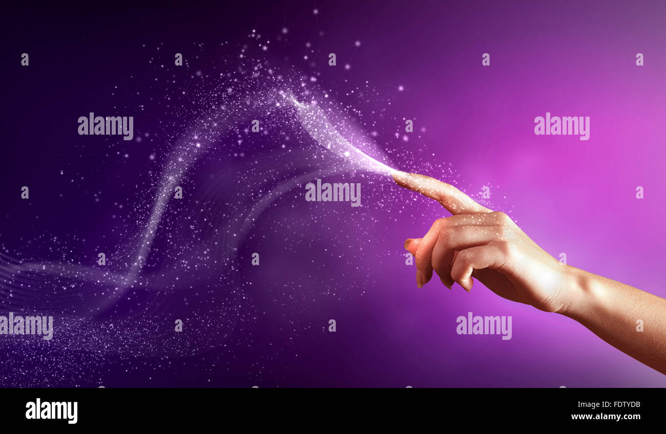 magical hand conceptual image with sparkles on colour background Stock ...