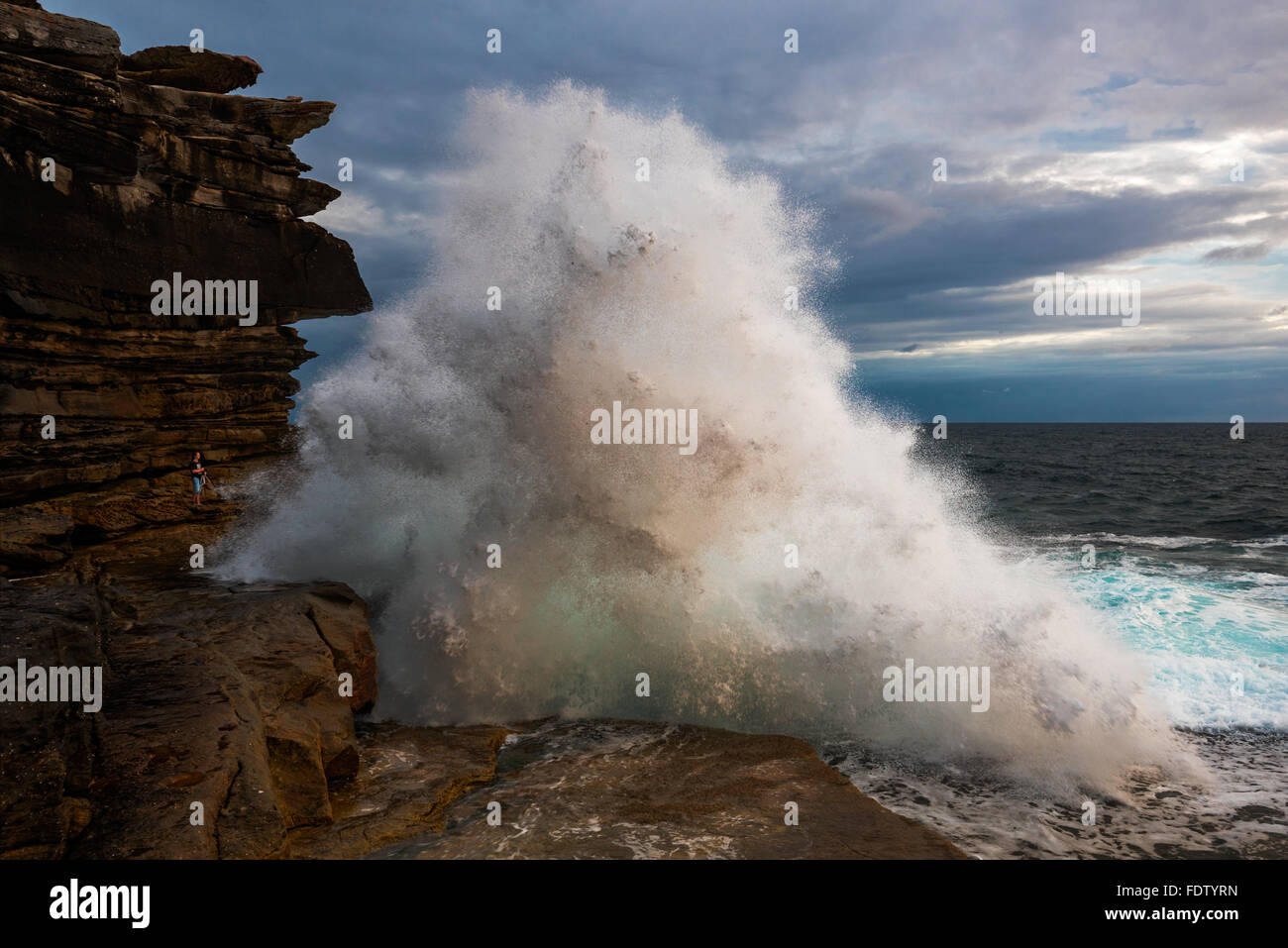 Brave man standing at the edge facing huge wave coming at him Stock ...