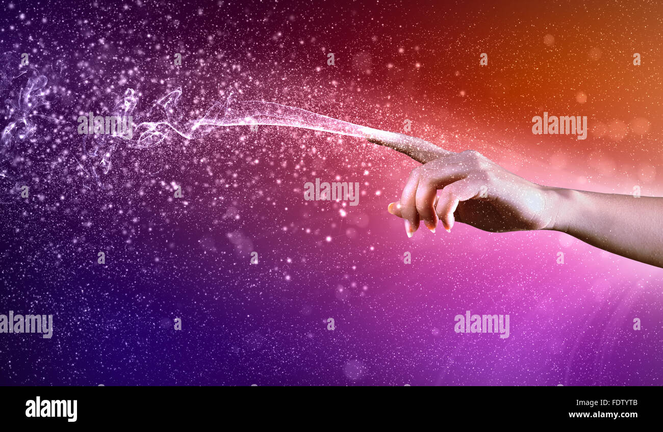 magical hand conceptual image with sparkles on colour background Stock ...