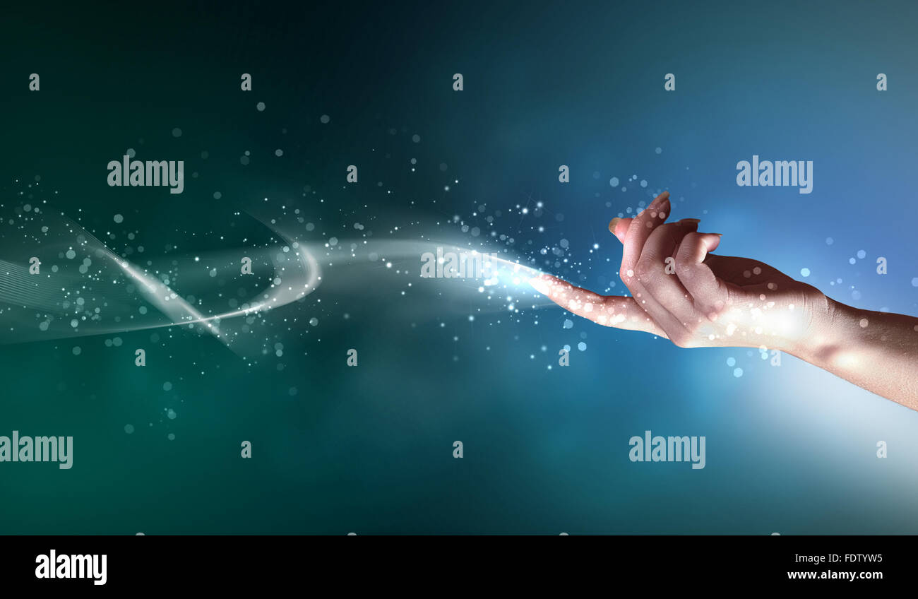 magical hand conceptual image with sparkles on colour background Stock ...