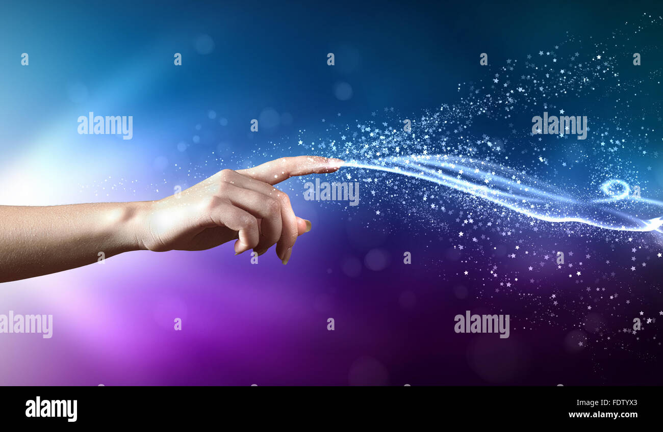 magical hand conceptual image with sparkles on colour background Stock ...
