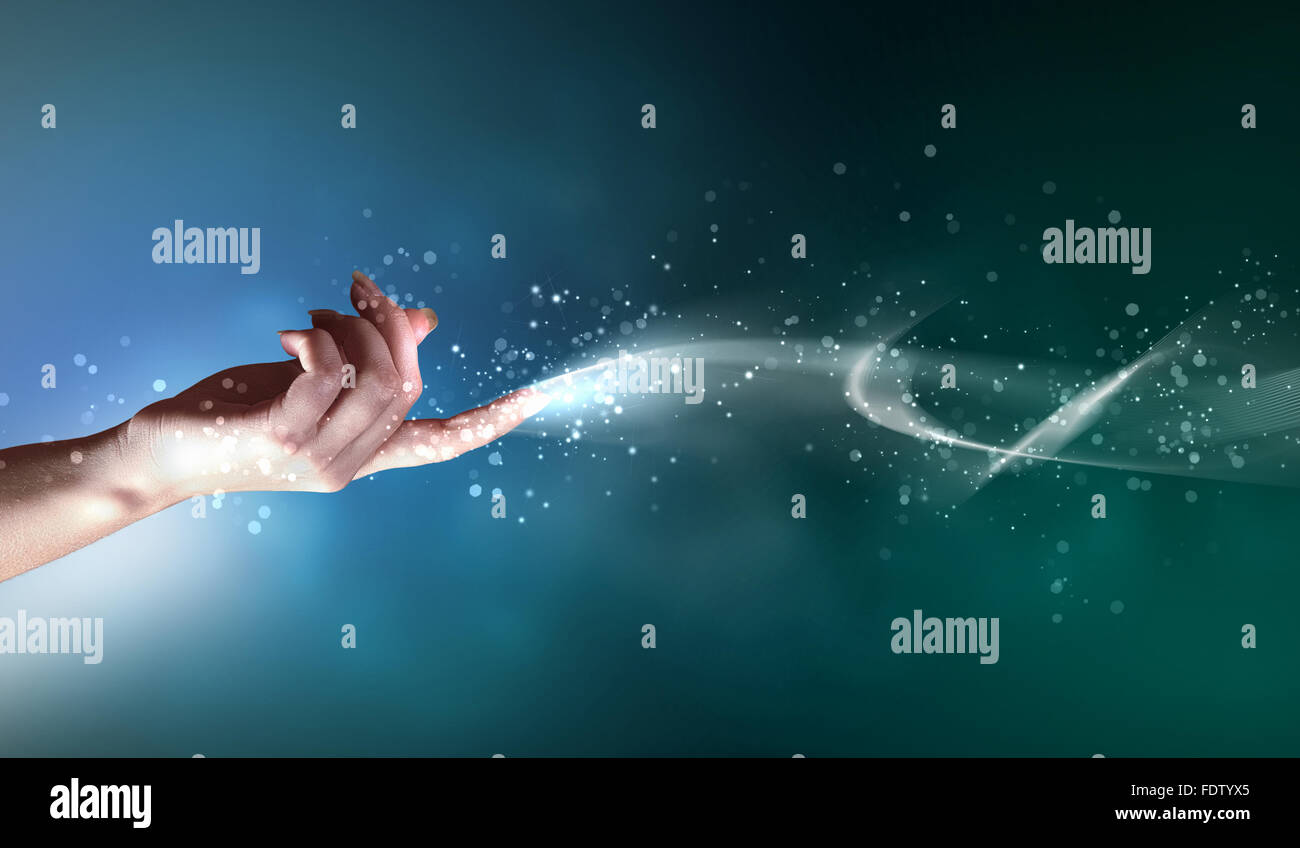 magical hand conceptual image with sparkles on colour background Stock ...